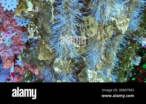 Christmas decorations and ribbons are arranged for sale, featuring ...