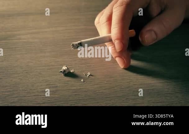 Smoker Hand On Table In Sunlight Stock Video Footage - Alamy