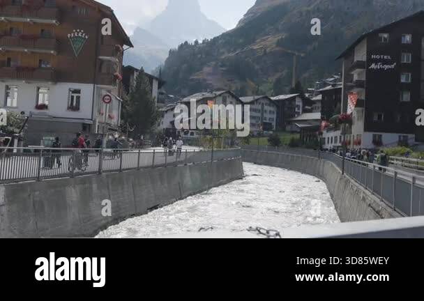 Evening view of Zermatt with alpine lodges along the river, the ...