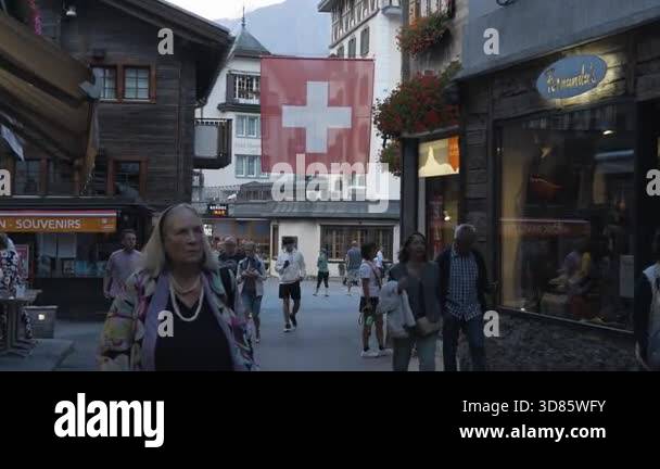 Zermatt, Switzerland - August 11, 2025: Evening walk through crowded ...