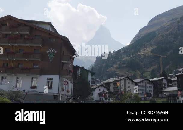 Evening view of Zermatt with alpine lodges along the river, the ...