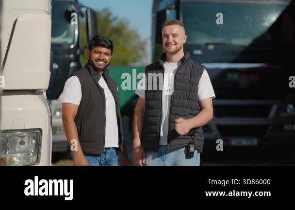 Multicultural team of two drivers smiling and showing thumbs up ...