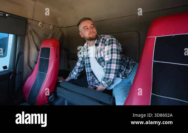 Exhausted long distance haulage professional lying down to rest on the ...