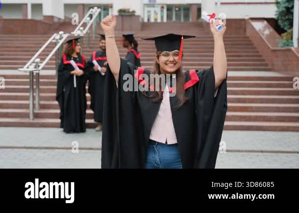 Proud indian female student in a gown and cap celebrating her ...