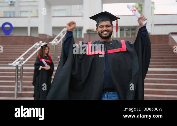 Successful indian graduate in a traditional gown and mortarboard ...