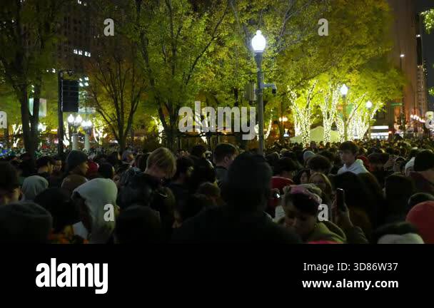 USA IL Chicago 21 Nov 2025. Large crowd gathers at night in park to ...