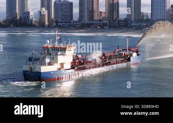 Aerial view of a dredging ship pumping sand in Gold Coast waters, with ...