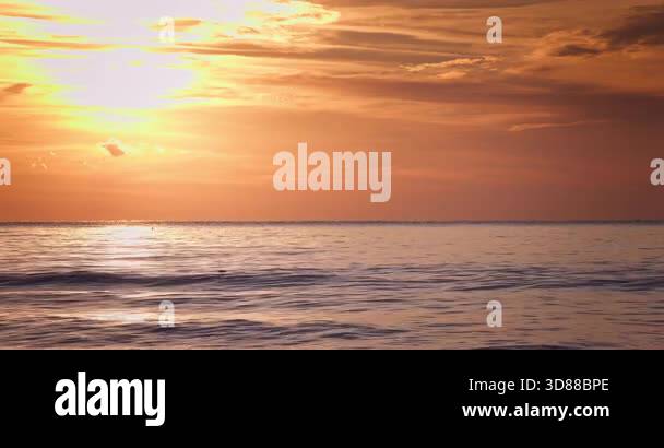 Scenic sunrise over the sea horizon and tropical island beach, the sun ...