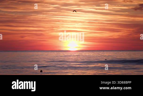 Scenic sunrise over the sea horizon and tropical island beach, the sun ...