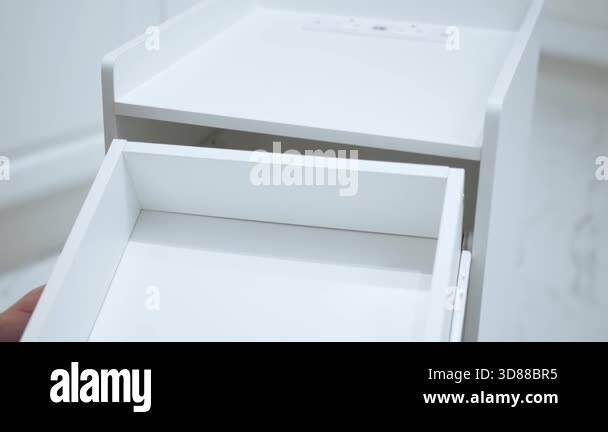 Installer sliding drawer into assembled dresser frame during final ...
