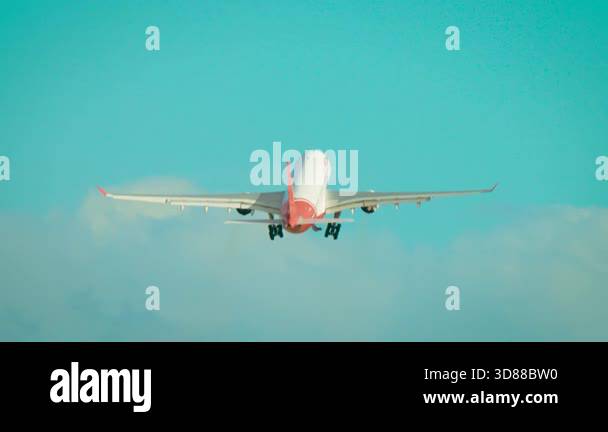 Passenger airplane taking off with landing gear retracting against ...