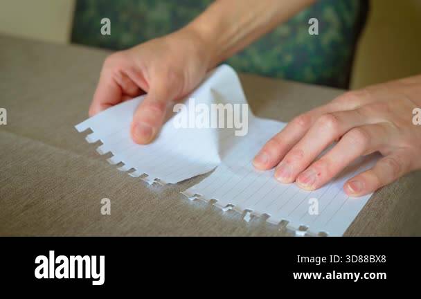 Tearing paper sheet into pieces reflecting psychological problems and ...