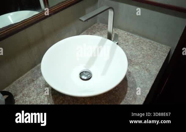 Modern Bathroom Fixtures Including Toilet, Sink, and Hygiene Essentials ...