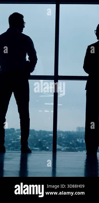 Two full-length silhouettes standing at the window. Male and female ...