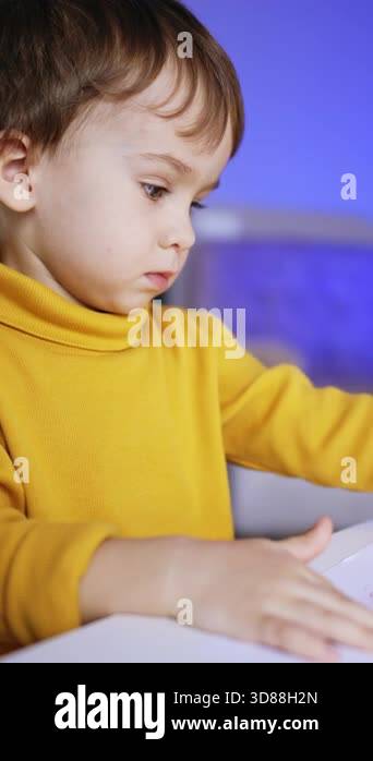 Serious cute Caucasian kid focused on drawing. Portrait of a lovely ...