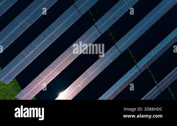 Long photovoltaic cells reflect the sunlight. Drone flight over the ...