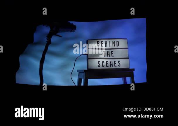 A cinematic view of a Behind the Scenes sign on a wooden stool under ...