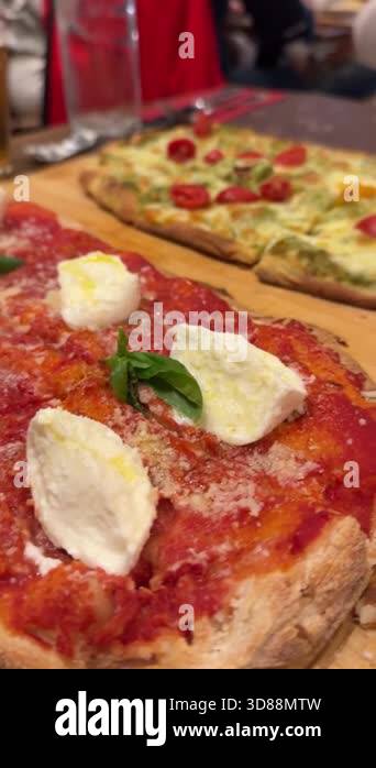 real Italian pizza stands on a board in a restaurant large mozzarella ...