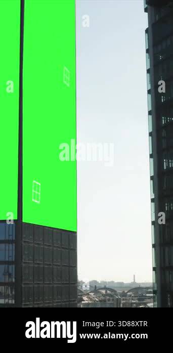 Rising footage of modern downtown skyscrapers with glossy grass facades ...