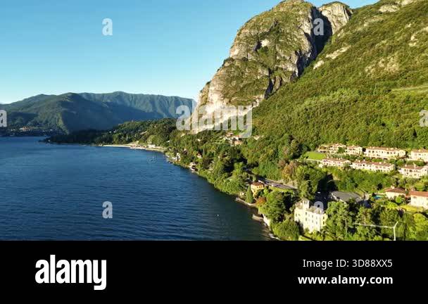 dramatic cliffside coastline overlooking deep blue lake, steep rock ...