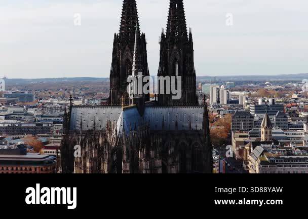Famous gothic Cologne Cathedral stands tall against cityscape. Aerial ...