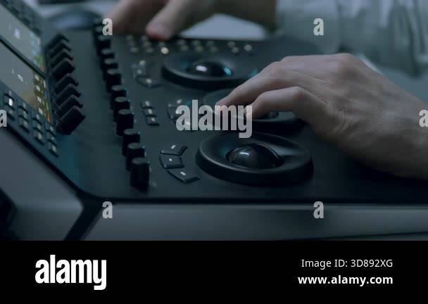 Skilled hands are focused on adjusting various controls on a ...