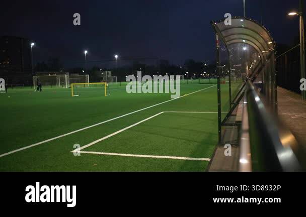 Night view of a football training session on an artificial turf field ...