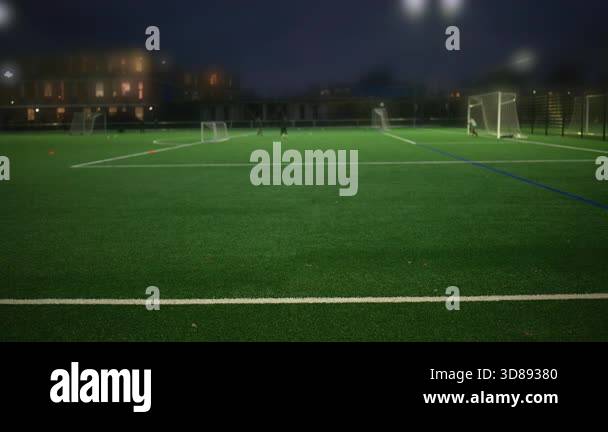 Night view of a football training session on an artificial turf field ...
