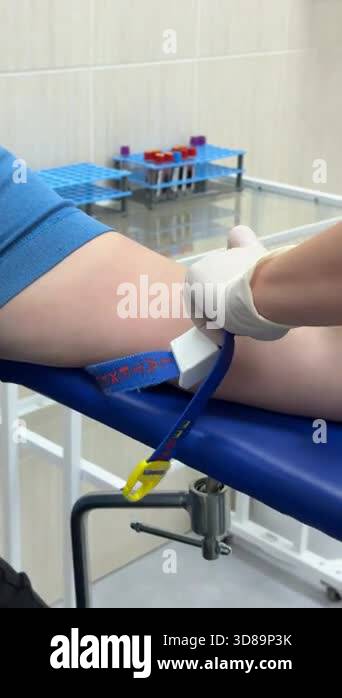 Doctor Applying Tourniquet On Patient Hand For Safe Blood Draw ...