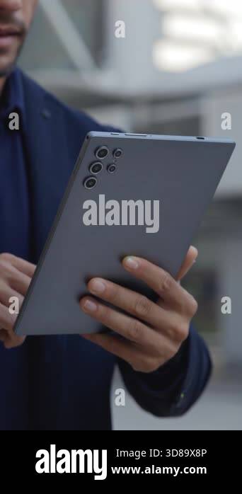 Closeup view of businessman hand hold tablet and texts on modern street ...