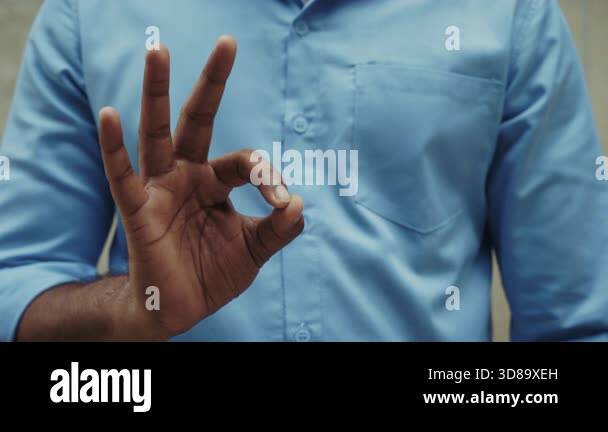 Crop view of Indian man shows Ok gesture while stands on grey ...