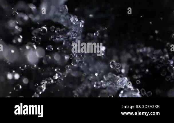 Super Slow Motion Shot of Falling Water Drops on Black Background at ...