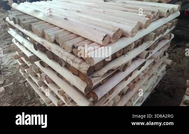 A stack of freshly cut wooden sticks, perfect for construction or ...