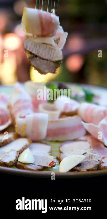 woman takes a piece of vacuum-packed frozen lard fat from a wooden ...