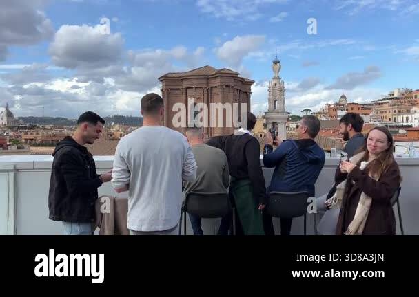 Rome rooftop terrace young woman photographs stylish businessmen ...