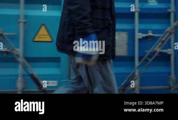 ALMATY, KAZAKHSTAN - OCTOBER 09 2025: Stevedore swiftly walks along ...