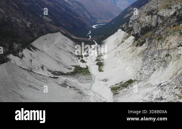Majestic aerial flight above a narrow river winding through a stunning ...