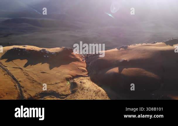 High angle drone footage flying over a rocky mountain pass towards a ...