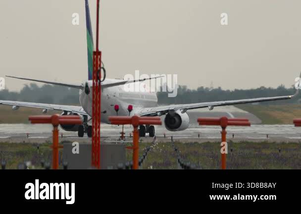 Jet airplane accelerating for takeoff, rear runway view. Concept of ...