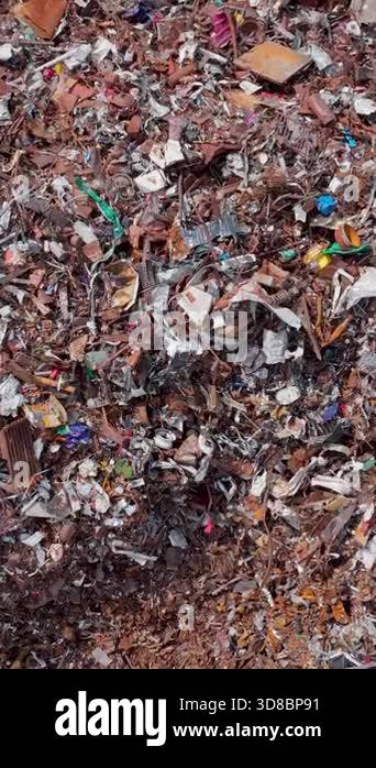 Vertical video. Mixed fragments of metal plastic rubber and wood cover ...