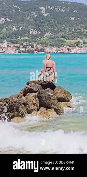 Young Woman Posing on a Rocky Cliff at Baska Beach, Krk Island, Croatia ...
