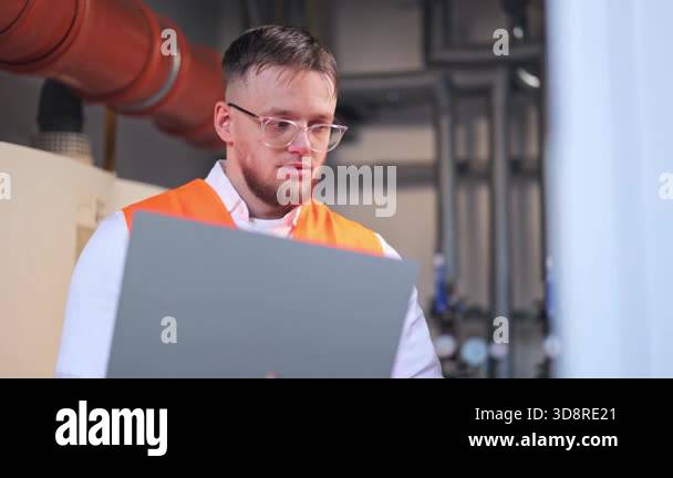 Professional engineer, focused and dedicated, reviews data on laptop ...