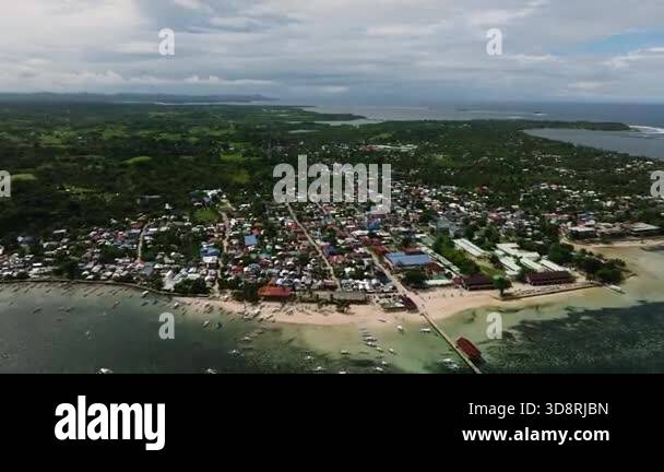 Coastal town with colorful rooftops lies near the shoreline surrounded ...