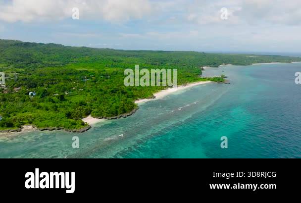 Turquoise water in beach with coral reefs. Carabao Island. Tan-agan ...