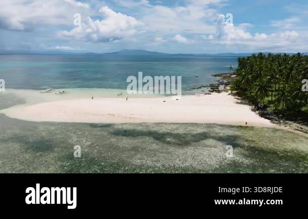 Tropical sandbar and palm beach with turquoise shallow water. Kawhagan ...