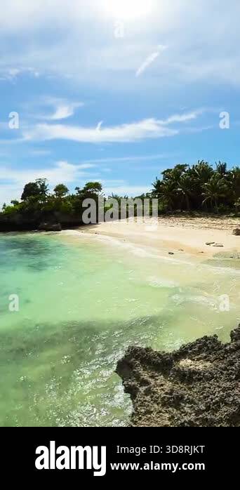 Turquoise sea water and waves in sandy beach. Carabao Island in Romblon ...
