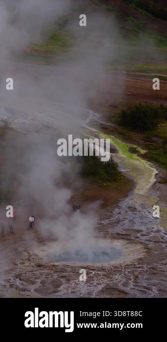 High angle aerial shot shows steam rising from a blue vent in Iceland ...