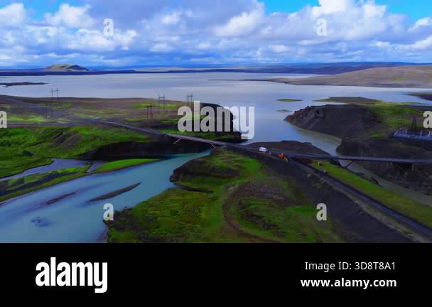 Aerial daylight view of turquoise meltwater, black volcanic banks ...