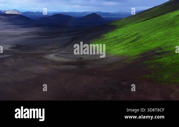 Aerial view of an Icelandic highland ash plain with a crater pond, a ...