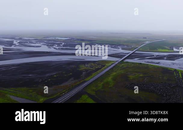 Aerial camera glides over Ring Road bridge on Iceland south coast as ...